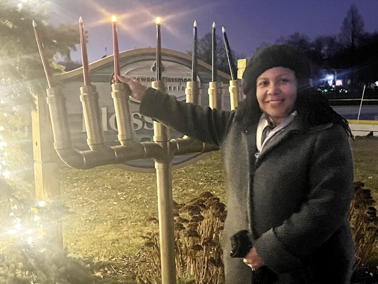 African American community members light the Kinara in Flossmoor Park ...